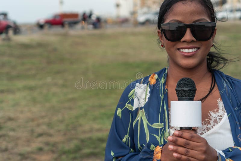 Presenter Speaking into Microphone while Standing in the City Stock ...