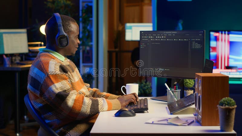 Black Programmer Remotely Working in Home Office Writing Code on ...