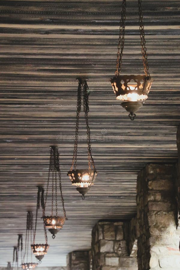 Black Punched Metal Chain Lights Hanging from Black and White Striped ...