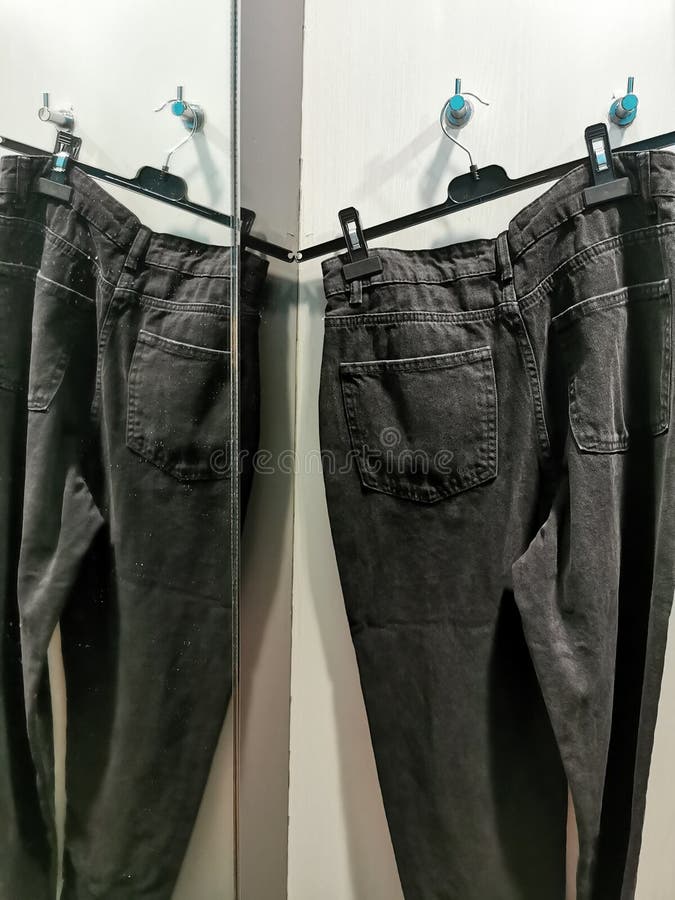 Black Ragged Jeans on Clothes Rack in the Dressing Room Stock Image ...