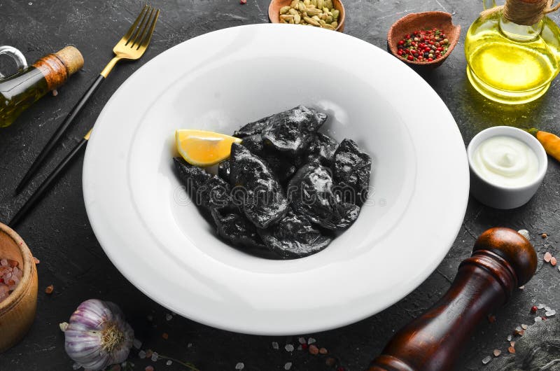 Black Ravioli with Meat and Sauce, on a White Plate. Stock Photo ...