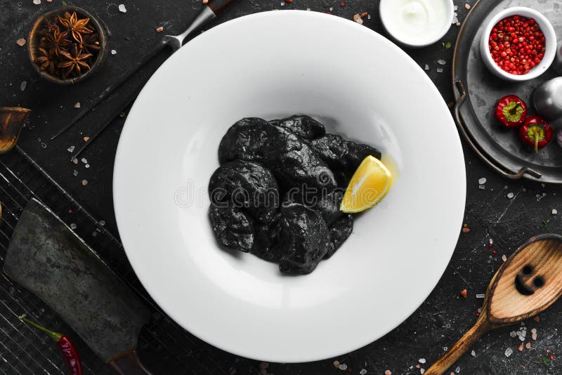 Black Ravioli with Meat and Sauce, on a White Plate. Stock Image ...