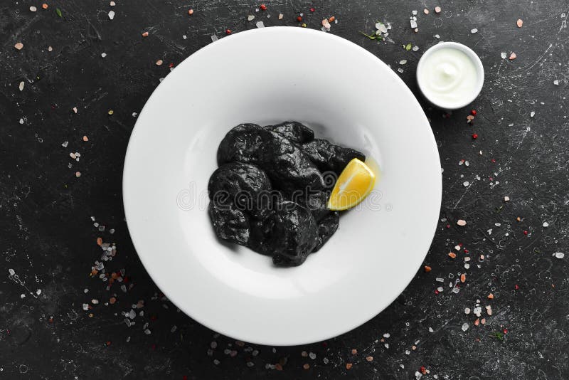 Black Ravioli with Meat and Sauce, on a White Plate. Stock Image ...