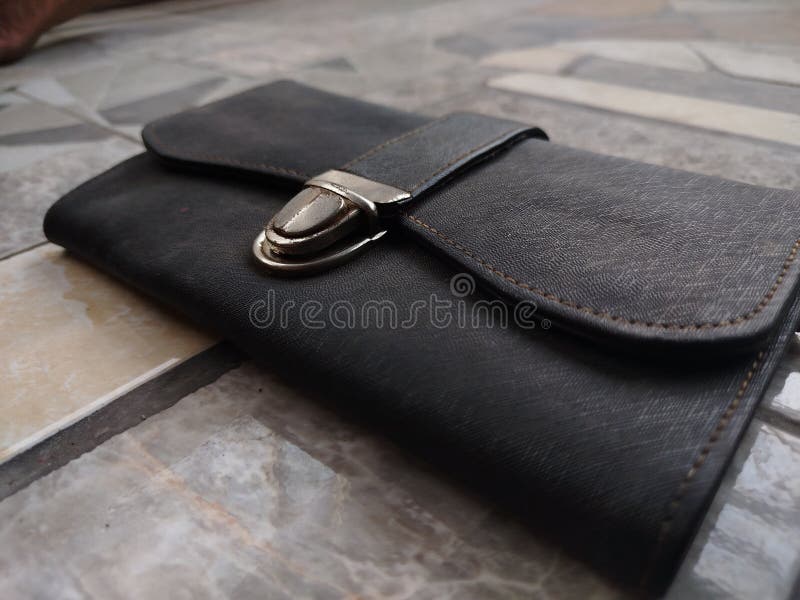 A Black Rectangular Wallet that is Dusty but Doesn& X27;t Lose Its ...