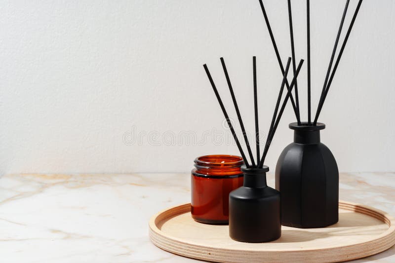 Black Reed Diffuser and Amber Candle on Wooden Tray Stock Photo - Image ...