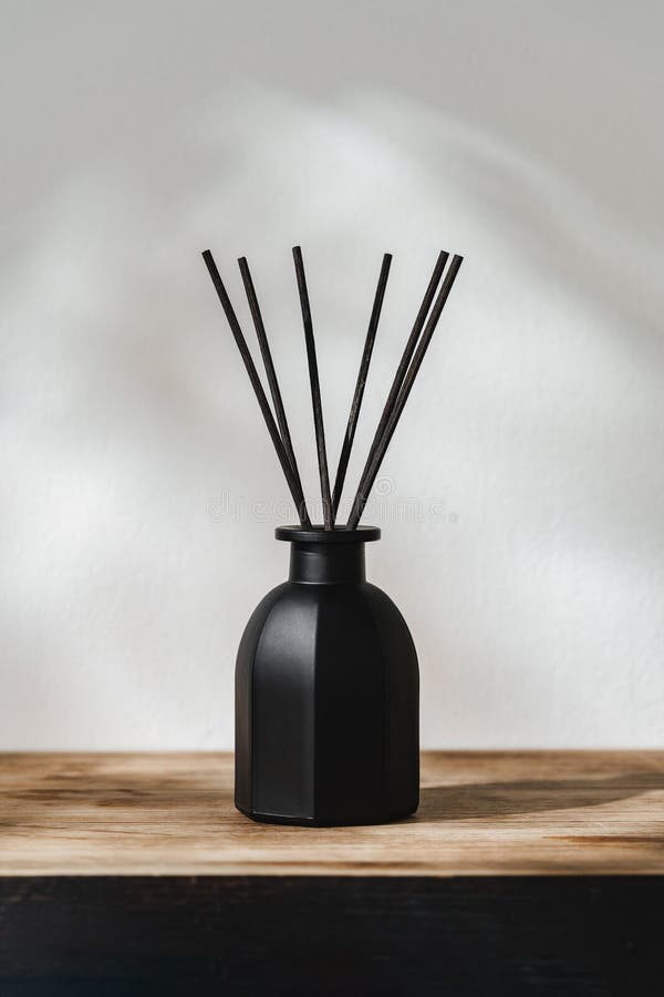 Black Reed Diffuser on a Wooden Table with Soft Light Casting Shadows ...