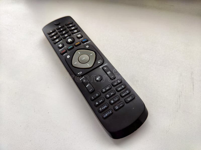 Remote Control Resting on a White Surface Showcasing Its Numerous ...