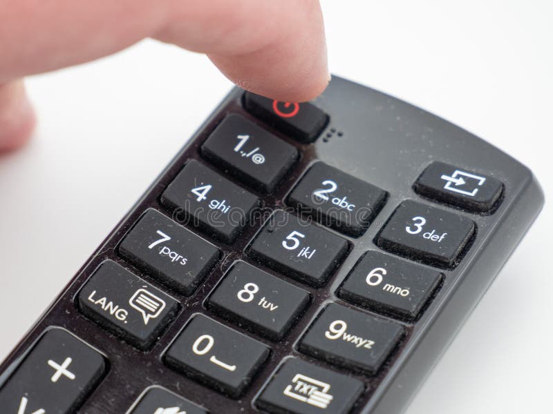 Black Remote Control Isolated on a White Background with a Finger ...