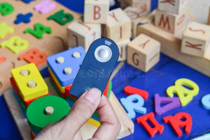 Black Remote Control Resting on a White Surface with Buttons in Focus ...