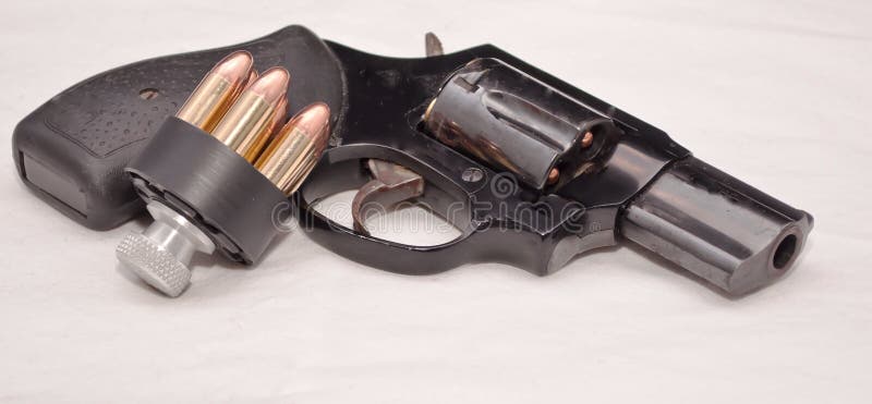 A Black Revolver with a Loaded Speed Loader in Front of it Stock Photo ...