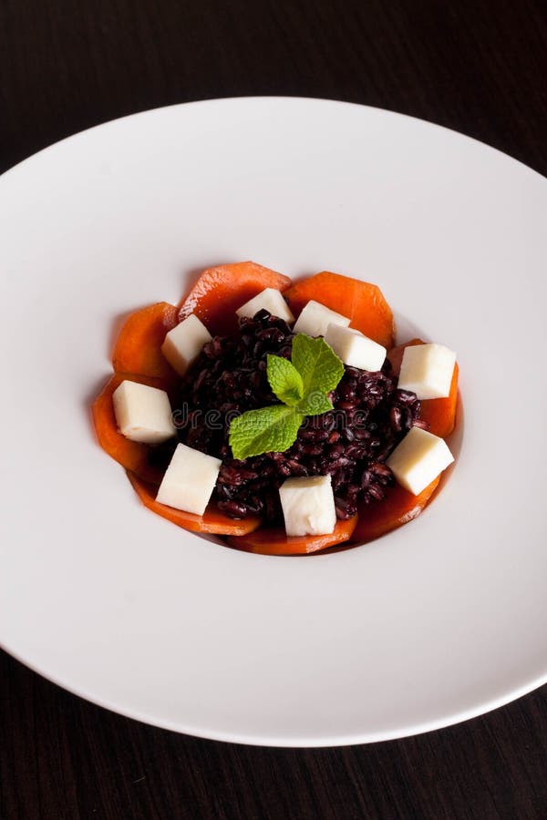 Black Risotto with Sliced Carrots and Cheese on White Plate Stock Image ...