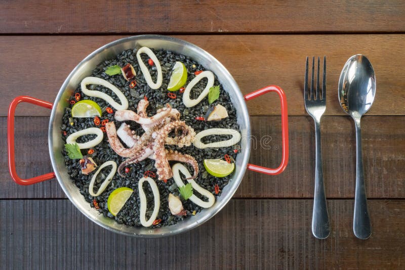 Black Squid Ink Risotto with Lightly Seared Calamar Stock Photo - Image ...