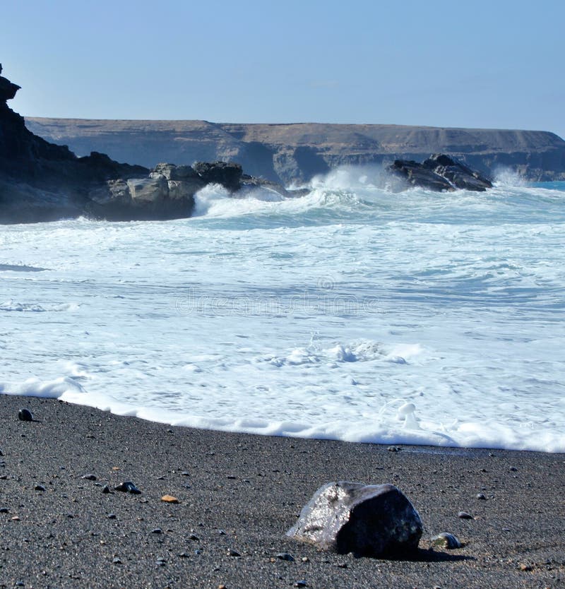 Black rock at the beach stock photo. Image of cliff - 269794746