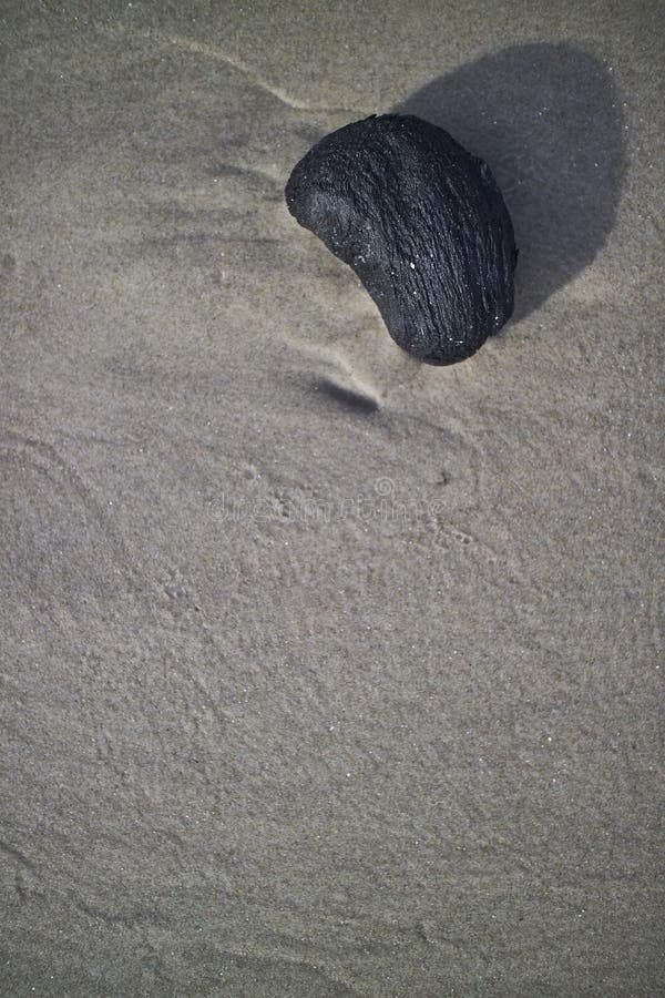 A rock laying in the sand stock photo. Image of denmark - 194121676