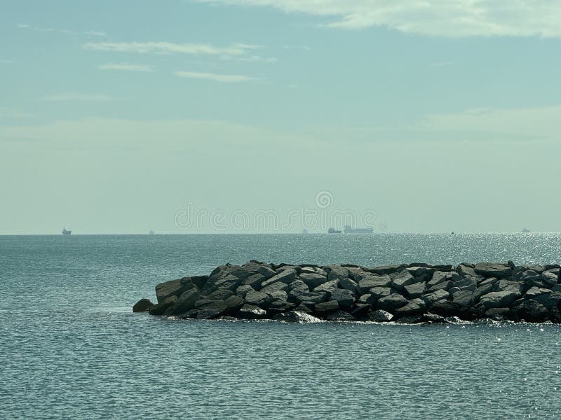Black Rocks Extending into the Sea Stock Photo - Image of beautiful ...