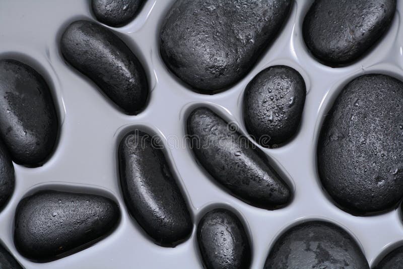 Black Rocks in Water stock image. Image of black, stones - 10610031