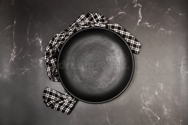 Black Round Flat Plate on a Black Marble Kitchen Counter Stock Image ...