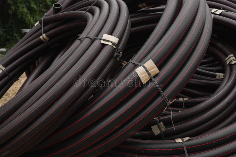 Black Rubber or Plastic Pipes with a Red Lines As a Construction ...