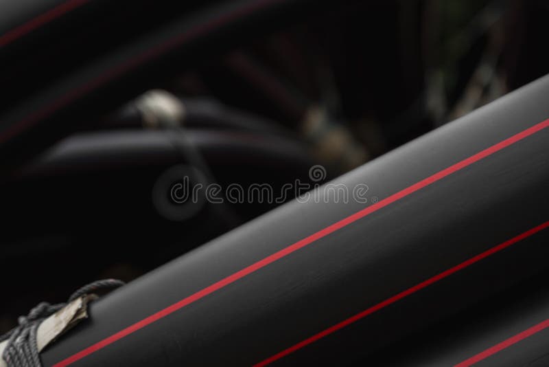 Black Rubber or Plastic Pipes with a Red Lines As a Construction ...