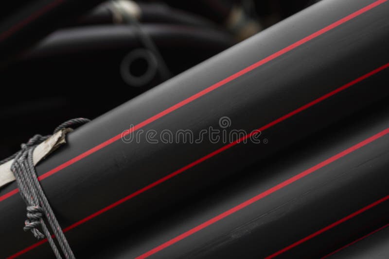 Black Rubber or Plastic Pipes with a Red Lines As a Construction ...