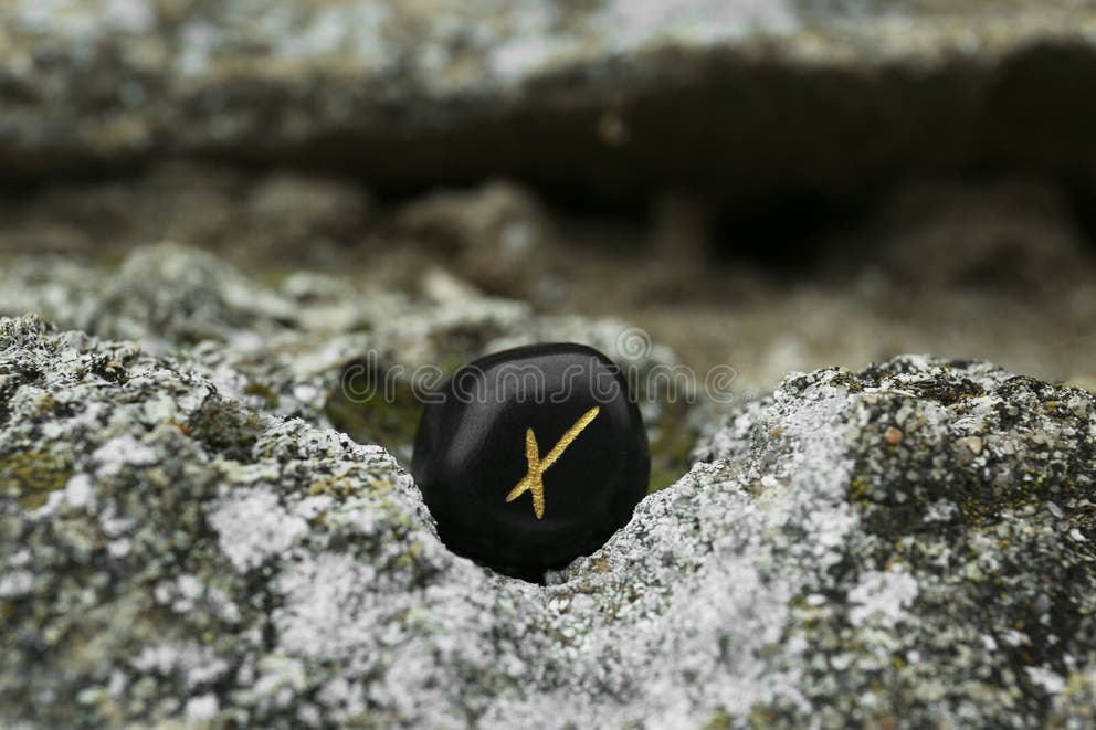 Black Rune Nauthiz on Stone Outdoors, Closeup Stock Photo - Image of ...