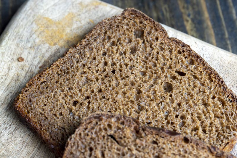 Black rye bread on a board stock photo. Image of cutout - 280859352