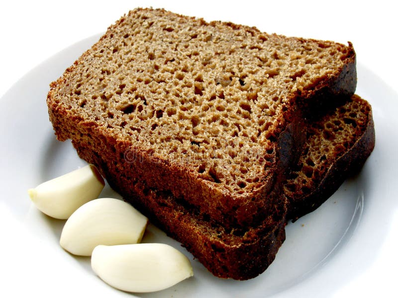 Black rye bread and garlic stock photo. Image of plate - 12369712