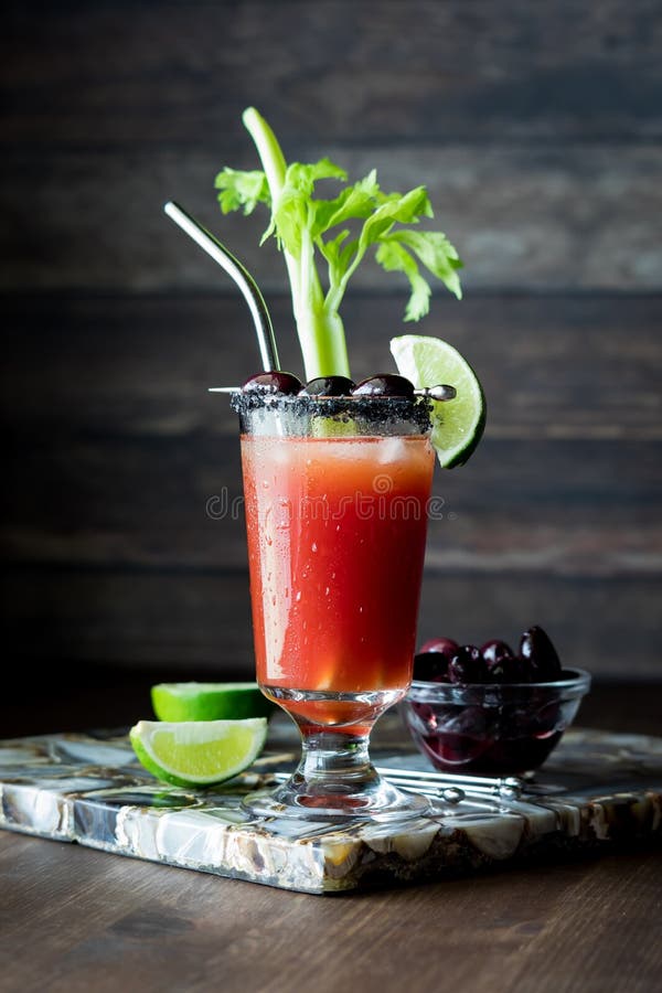 A Black Salted Rim Caesar Cocktail Garnished with Black Olives, Celery ...