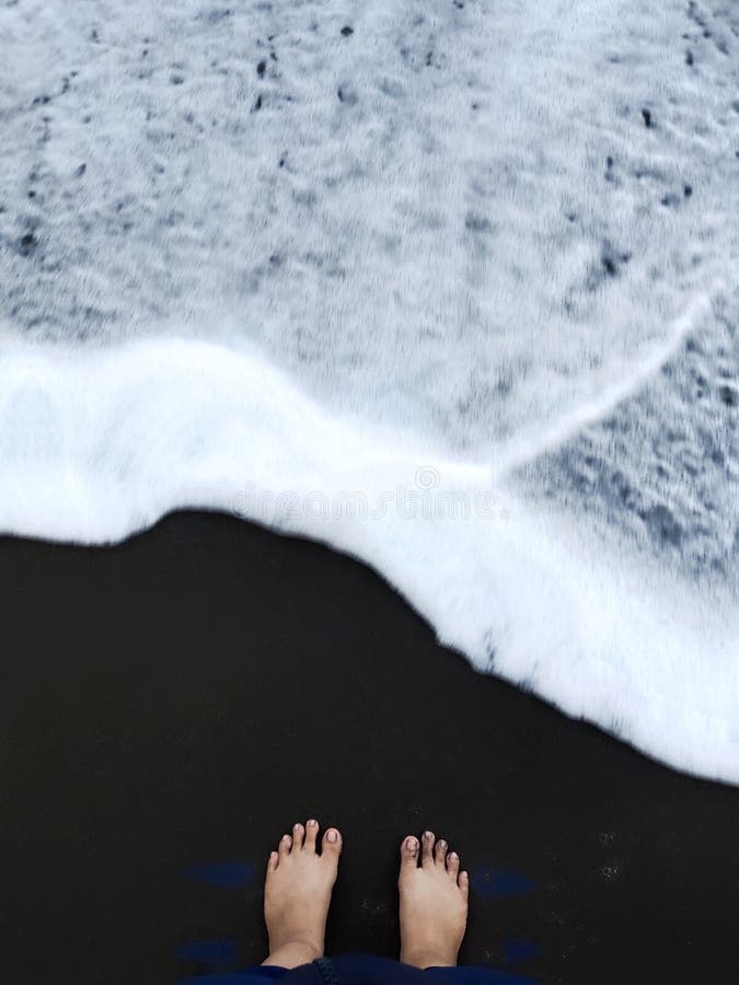 Black Sand Beach with White Tiny Buble Stock Image - Image of black ...