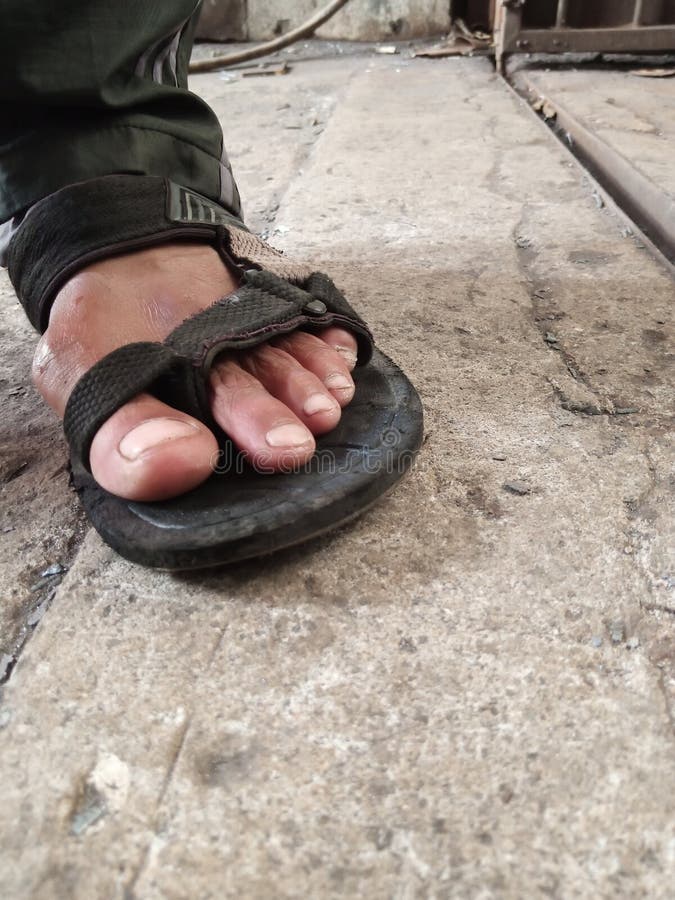 Black Sandals Worn on the Left Foot Stock Photo - Image of foot, left ...