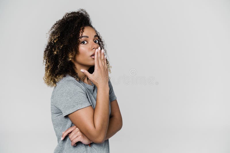 The Black Scared Woman Standing Sideways while Covering Her Mouth with ...