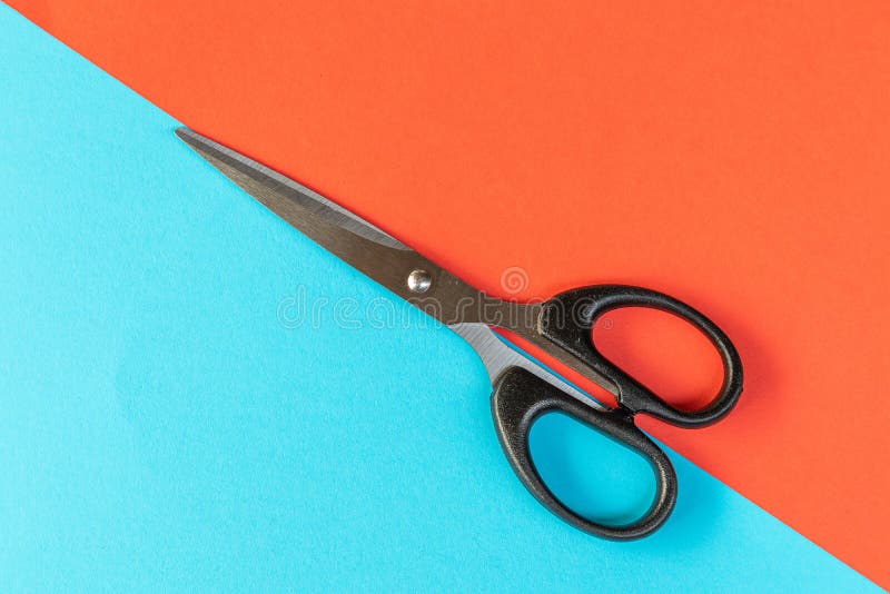 Black Scissors on Blue and Red Color Paper Texture Background. Stock ...