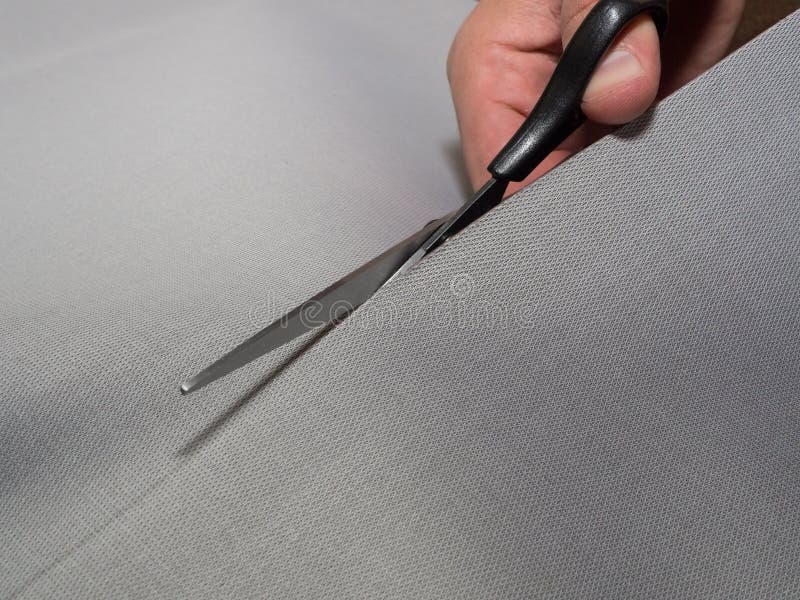 Black Scissors Cutting Fabric. Concept of Textile Cutting-out Stock ...