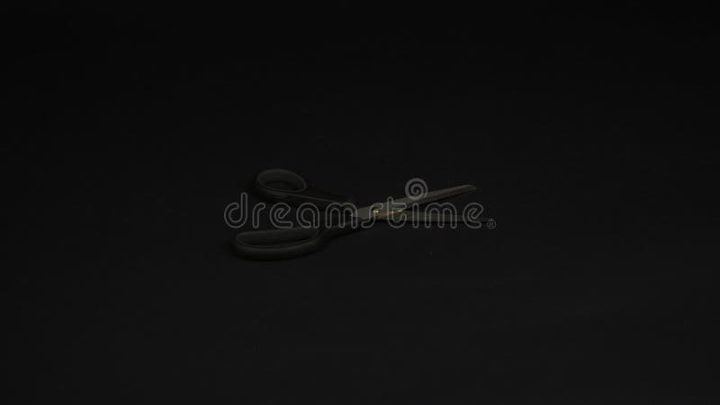 Black Scissors Isolated on a Black Background. Stock Photo - Image of ...