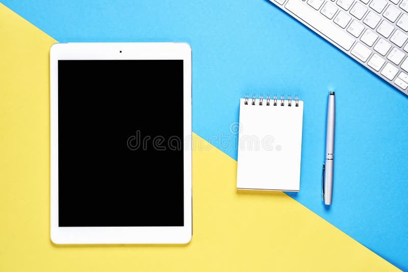 Black Screen Tablet Blank and Notebook Placed on Pastel Yellow and Blue ...