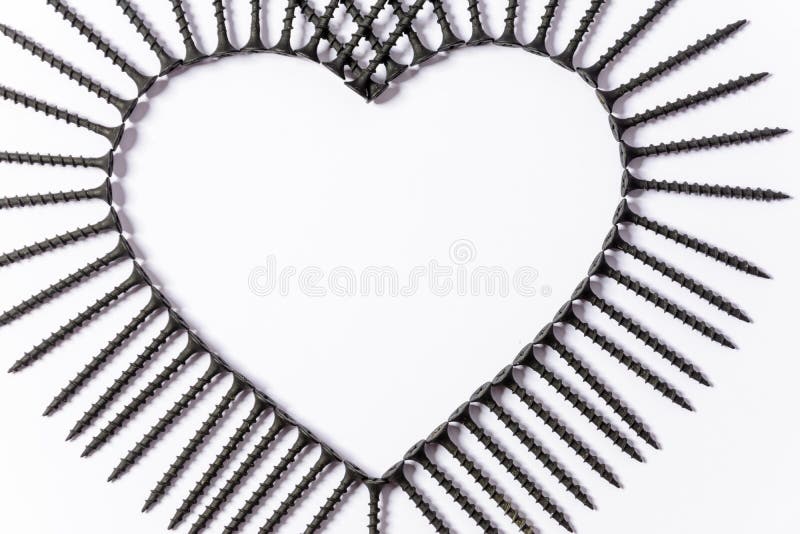 Black Screws Laid Out in the Shape of a Heart on a White Background ...