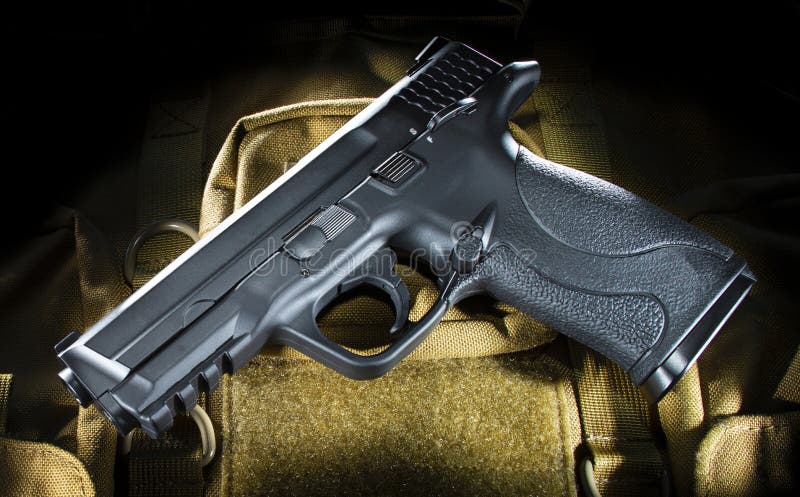 Semi Auto Handgun on Tan Material Stock Photo - Image of concealed ...