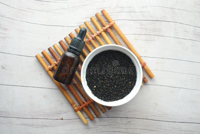 Black Sesame in a Container with Oil in a Jar on Table. Stock Image ...