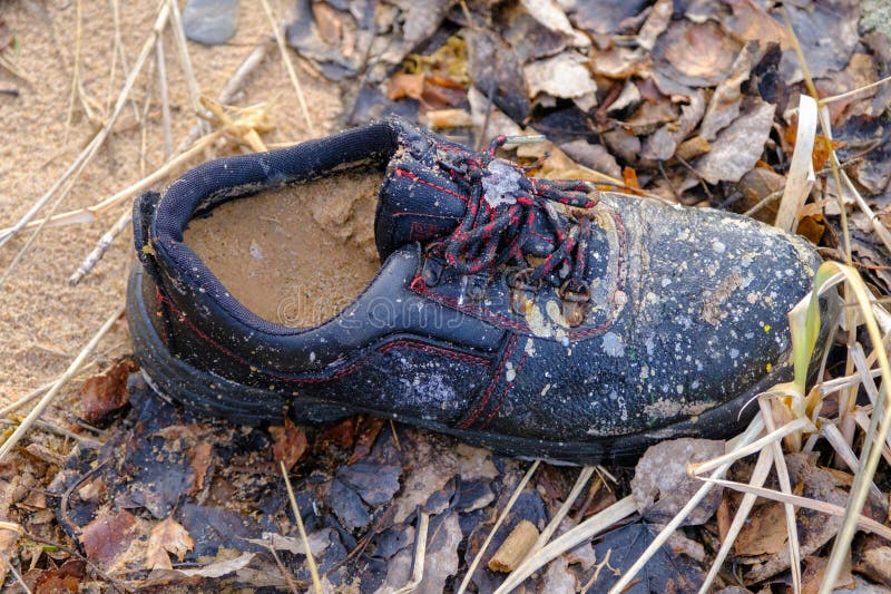 A Black Shoe Filled with Sand. a Shoe Washed by the Sea Stock Photo ...