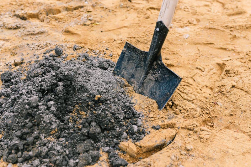 Black Shovel in the Sand. a Tool for Scooping Up Sand in Construction ...