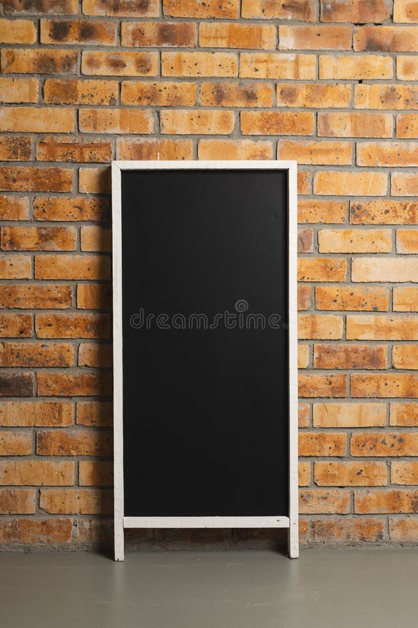 Black Sign in White Frame and Copy Space on Brick Wall Background Stock ...
