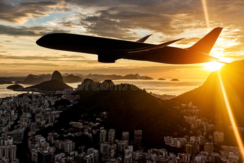 Black Silhouette of an Airplane Over the City on Sunset Stock Photo ...