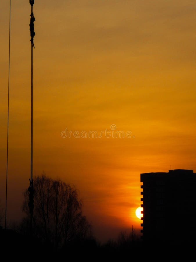 Black Silhouette of a Multi-storey Building Against the Orange Sunset ...