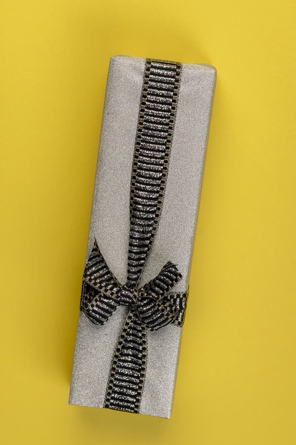 With a Black and Silver Ribbon Tied with a Silver Gift Package Stock ...