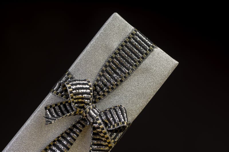 With a Black and Silver Ribbon Tied with a Silver Gift Package Stock ...