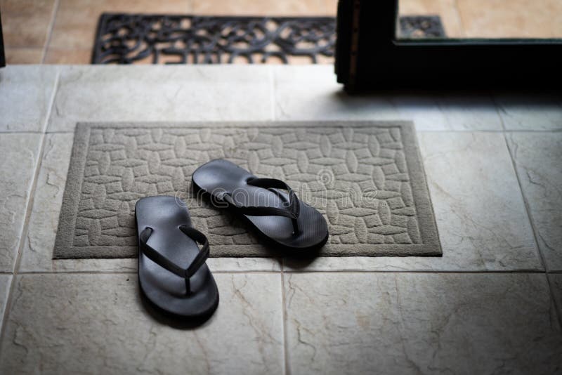 Black Slippers Lay on the Doormat in Front of the Room Stock Image ...