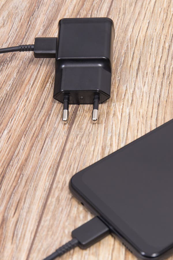 Black Smartphone and Charger Using To Charge Empty Battery. Various ...