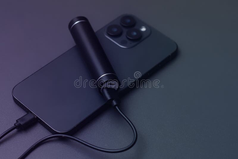 Black Smartphone is Charging from a Black Portable Power Bank on a Dark ...