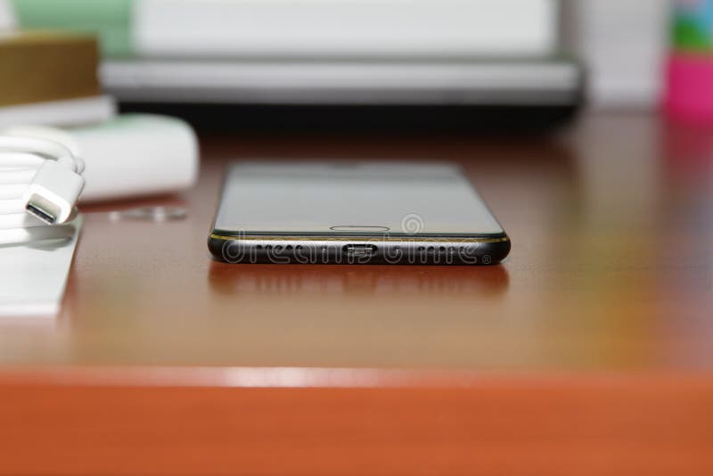 Black Smartphone Lying on a Wooden Table Stock Image - Image of ...