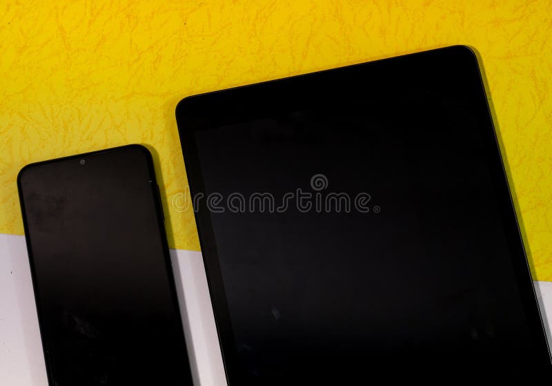 Modern Black Smartphone and Tablet on a Yellow Background Stock ...